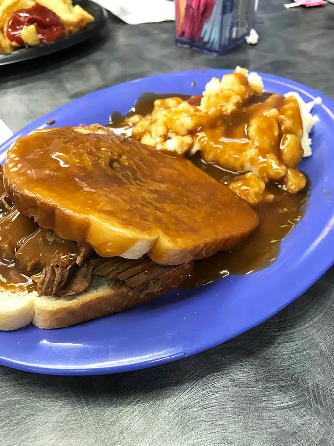 Hot roast beef sandwich swimming in gravy with a side of tater tots—comfort food that wraps around your soul like a warm blanket on a cold day.