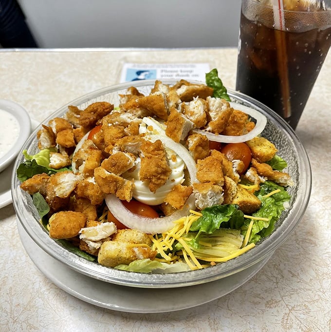 A salad that doesn't apologize for being hearty – crisp greens playing host to golden chicken and a supporting cast of fresh vegetables.