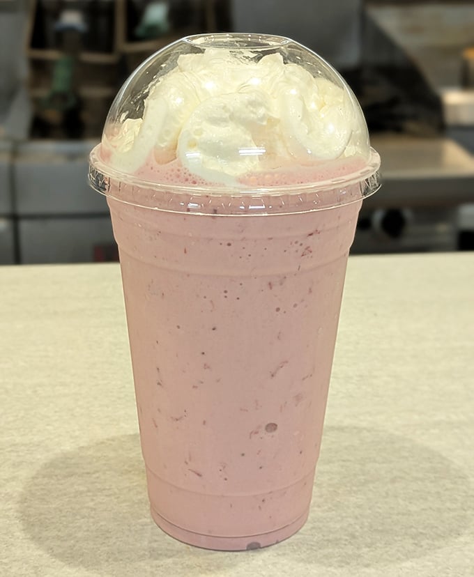 A strawberry shake that bridges the gap between dessert and beverage – the kind of pink cloud that makes adults remember why being a kid was so great.