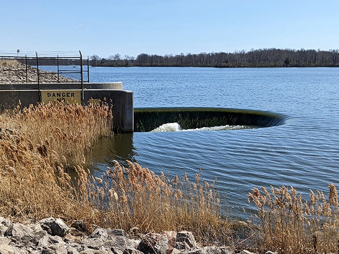 The spillway – where water performs its own version of a magic trick, disappearing over the edge in a mesmerizing display.
