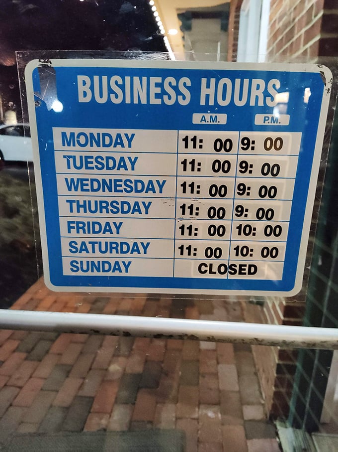 Business hours posted clearly – because knowing exactly when you can get your next cheesesteak fix is essential information.
