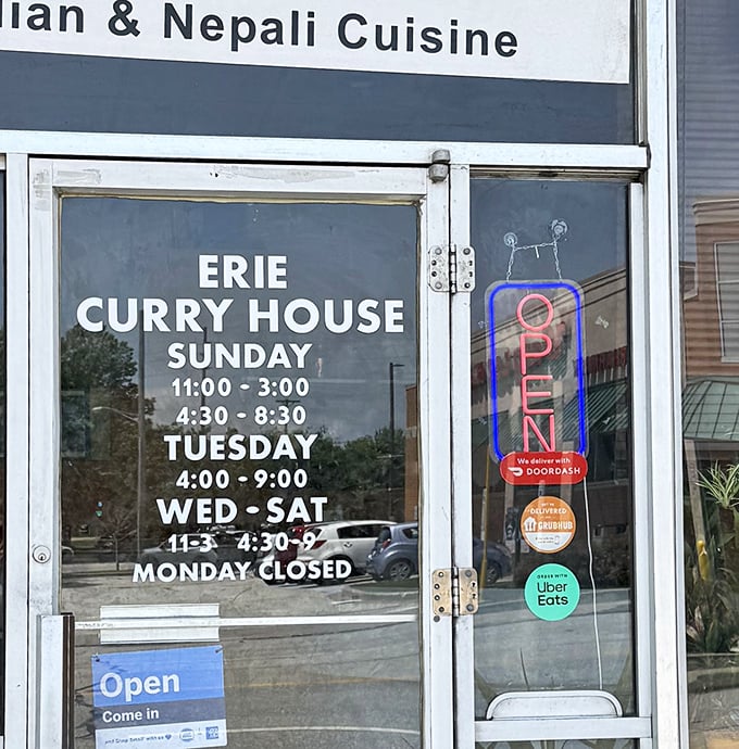 The hours posted clearly on the door – essential information for planning your curry pilgrimage to this Erie landmark.