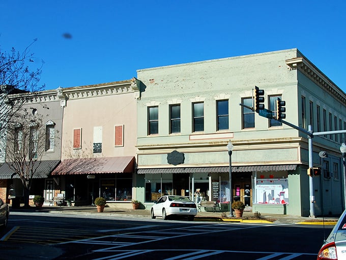 These pastel storefronts maintain their historic charm while housing modern businesses. Small-town retail therapy at its most picturesque!
