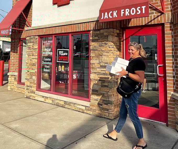 The universal joy of walking away with that distinctive red and white box. What's inside won't survive the car ride home.