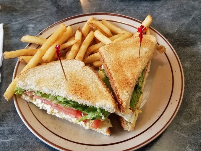 A sandwich architecture masterclass—perfectly toasted bread, crisp lettuce, and a filling generous enough to require both hands and several napkins.