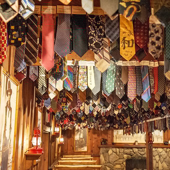 The necktie collection overhead isn't just decoration—it's a warning to all who enter wearing business attire. Hundreds of former ties stand witness.