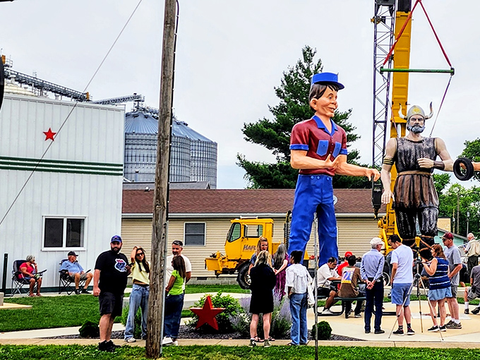 Crowds gather to witness a giant installation. These massive figures require serious equipment to stand tall—and provide the perfect backdrop for America's most unique vacation photos.