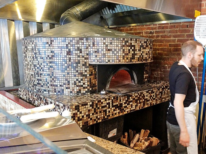 The mosaic-tiled wood-fired oven—the beating heart of Mercurio's where dough transforms into dreams at 900 degrees.