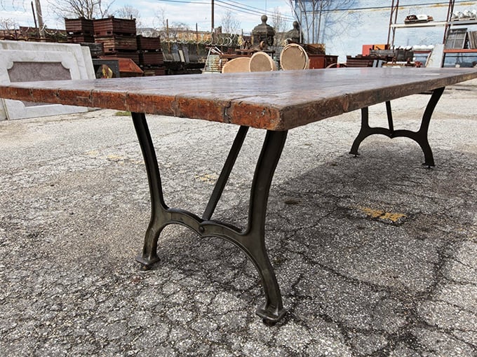 This isn't just a table—it's industrial poetry. Weathered wood meets cast iron in a marriage that's outlasted most Hollywood relationships.