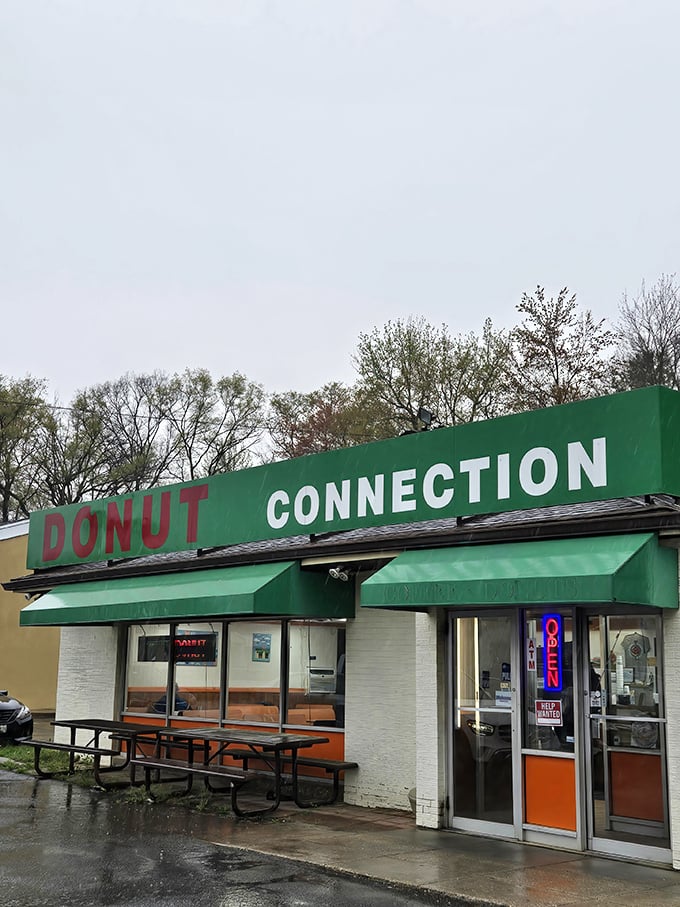 That no-nonsense green sign has been guiding hungry travelers to donut satisfaction since before fancy toppings were a thing.
