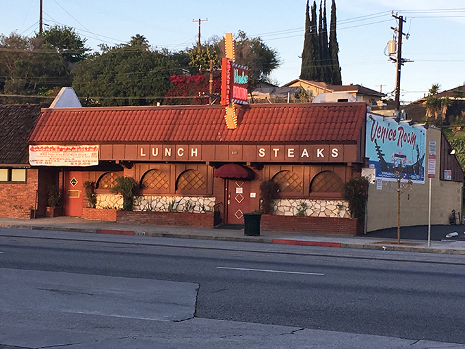 Classic American steakhouse architecture where red booths and dim lighting set the perfect beef-eating mood.