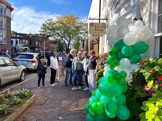 Old Town Alexandria's charm extends to its thrift scene—white brick and balloons welcome savvy shoppers.