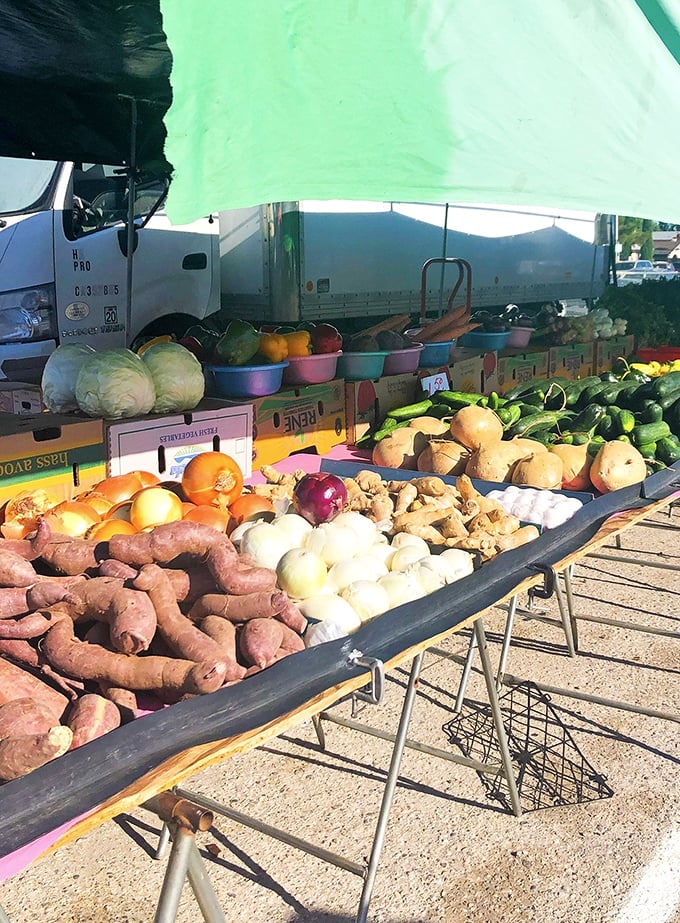 Sweet potatoes, onions, ginger, and fresh greens—Fresno Flea Market's produce section is a vibrant harvest of wholesome goodness.