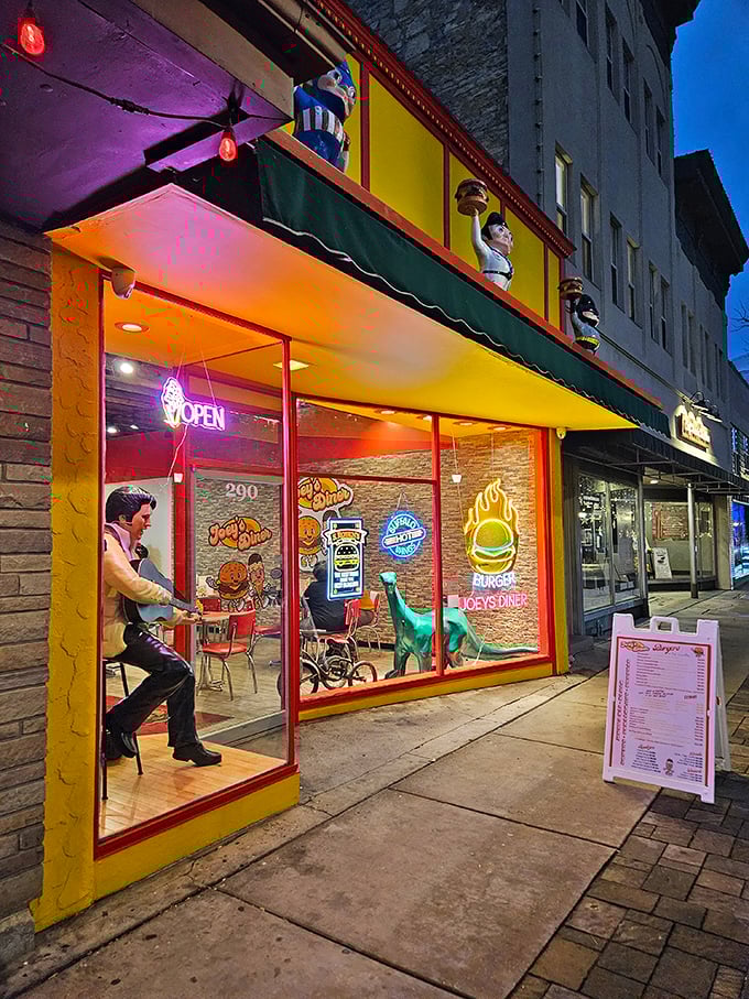By night, Joey's neon glow transforms it into a Waukesha wonderland. Those figurines aren't just watching—they're getting hungry too.