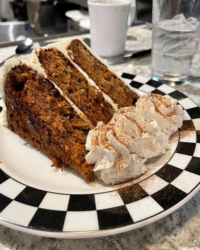 Carrot cake that defies gravity and expectations—moist layers stacked high with cream cheese frosting that makes you question why chocolate gets all the glory.
