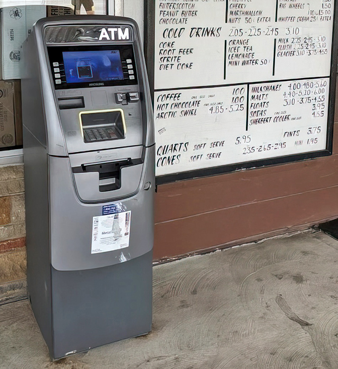 Modern meets classic – an ATM stands beside a handwritten menu board, bridging convenience with the timeless appeal of tradition.