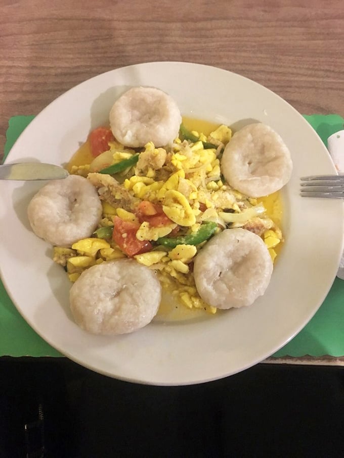 Ackee and saltfish surrounded by dumplings—Jamaica's national dish looking like sunshine on a plate, ready to brighten your day.