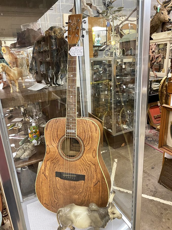 A beautifully grained Alvarez acoustic guitar stands ready to play songs of yesteryear. Its wood has aged like fine whiskey – better with time.