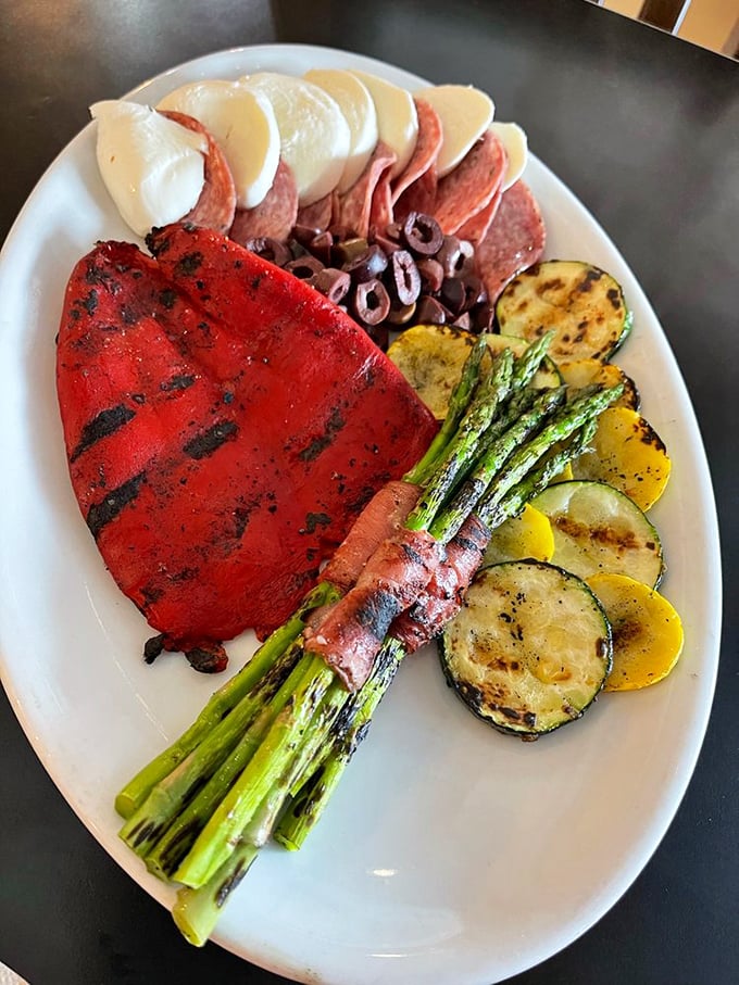 This antipasto platter isn't just appetizer—it's edible artwork featuring grilled vegetables, cured meats, and cheese that's traveled farther than most people's passports.