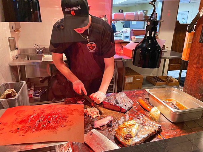Where the magic happens – a pitmaster's hands transform humble cuts into transcendent barbecue through skill and patience.