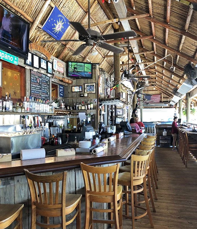 The tiki bar's wooden beams and thatched ceiling create the perfect Florida atmosphere – like dining in a shipwreck that's been tastefully redecorated.