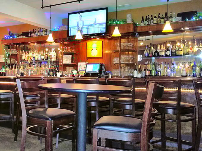 The bar area glows with amber light, promising libations that complement rather than compete with the Southern-Caribbean menu.