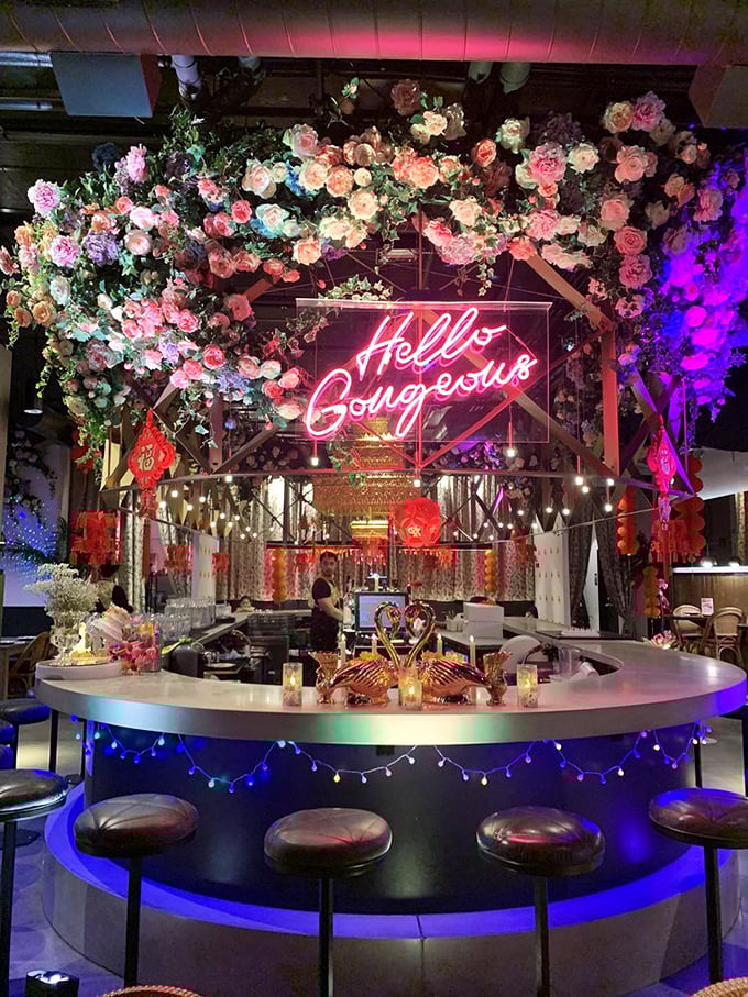 The "Hello Gorgeous" sign isn't just for the customers—it's what the food whispers to you as it arrives at your table under this floral canopy.