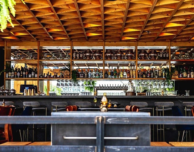 A bar stocked like this isn't just serving drinks—it's telling stories of New Orleans classics and California innovations, one pour at a time.