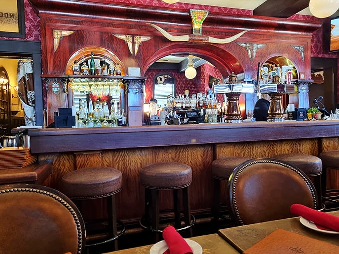 The bar beckons with promises of libations that complement perfectly charred proteins. Those leather stools have supported generations of happy diners.