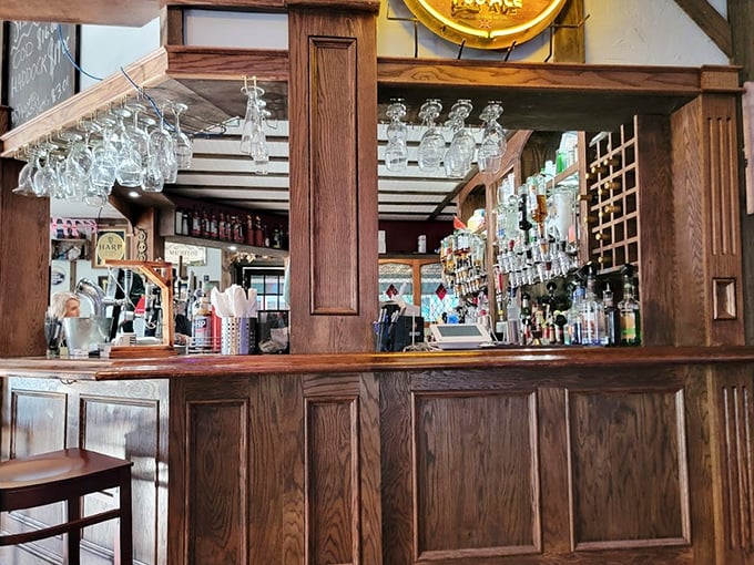 The polished wooden bar showcases an impressive array of spirits. That's not just a drink selection – it's a liquid library!