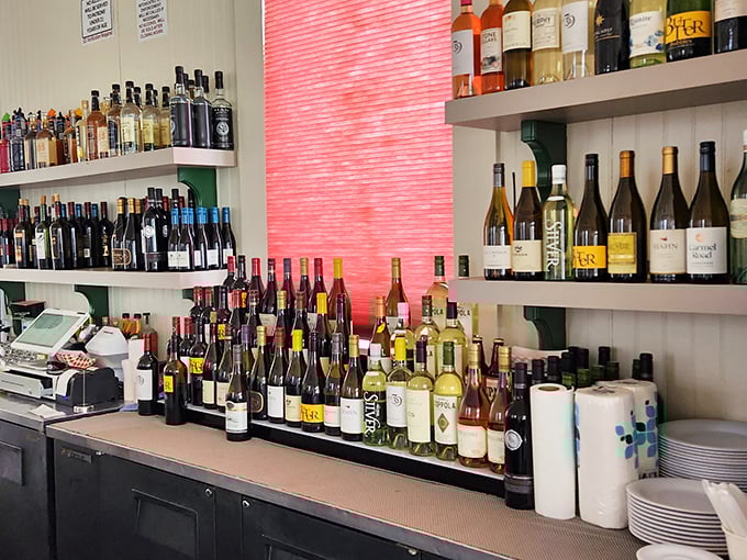 A well-stocked bar that promises the perfect pairing for whatever treasure from the sea you've selected. Wine bottles stand at attention, ready for duty.