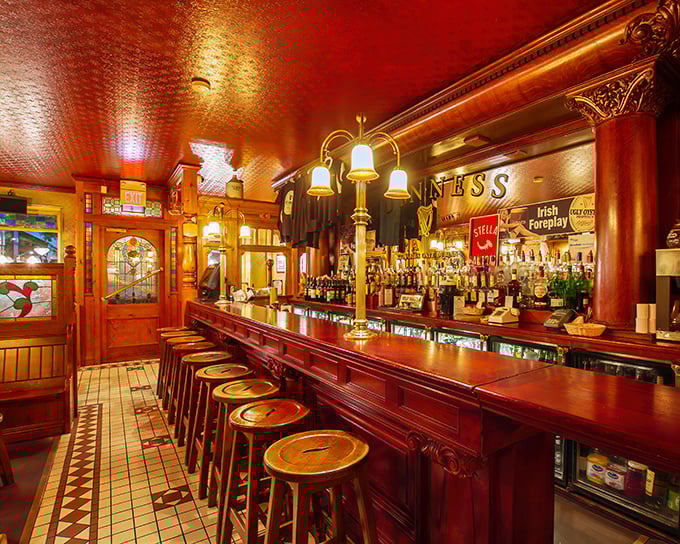 This isn't just a bar—it's a cathedral of conviviality where the polished wood has absorbed decades of laughter, secrets, and the occasional spilled Guinness.