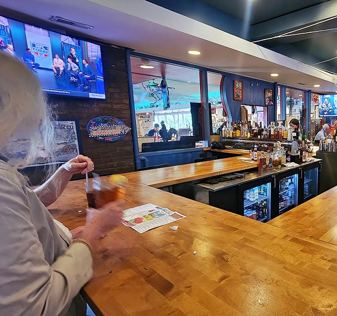 Not just a bar – it's command central for liquid refreshment. The wooden bartop has supported countless elbows and chicken-induced happiness.