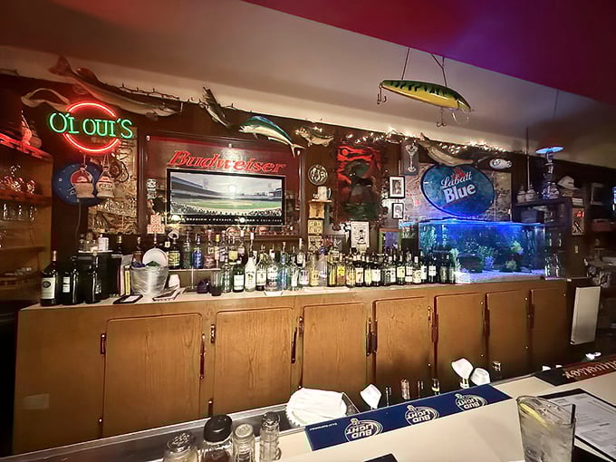 The bar at Loui's isn't designed—it evolved, like a living museum of good times where fishing lures and neon signs coexist in perfect harmony.
