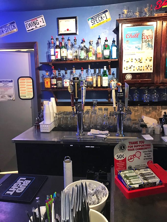 The bar area isn't just serving drinks—it's serving community. Those license plates on the wall have stories almost as good as the cocktails.
