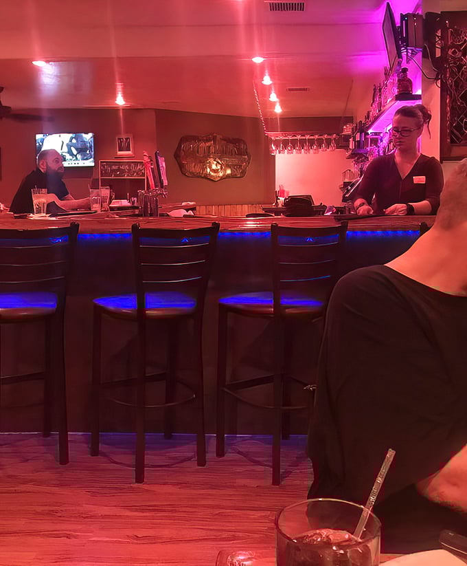 The bar area glows with that perfect mix of ambiance and practicality – dark enough to feel cozy, bright enough to see your drink. The kind of place where strangers become friends.