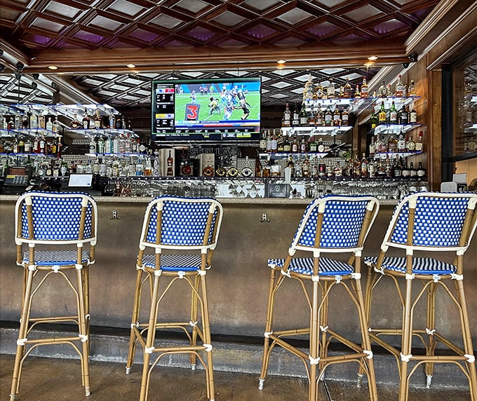 The bar area combines maritime charm with Miami cool—where blue bistro chairs invite you to perch and watch the bartender's seafood-pairing magic.
