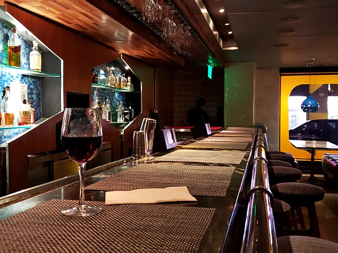 The bar's warm wood tones and hexagonal placemats create the perfect perch for wine sipping and people watching.