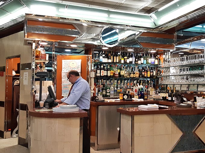 The bar area – where evening conversations flow as smoothly as the drinks, under the watchful gaze of bottles lined up like old friends.