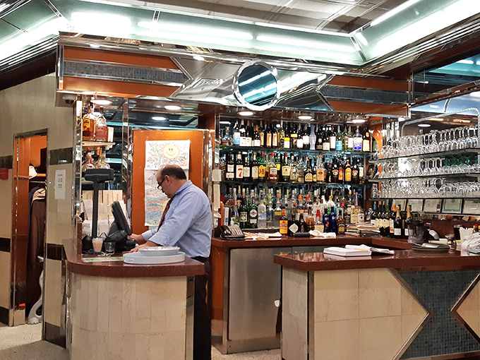 The bar area – where evening conversations flow as smoothly as the drinks, under the watchful gaze of bottles lined up like old friends.