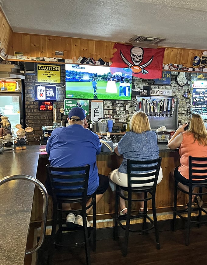 The bar area—where sports on TV and barbecue tales flow freely. Notice the Tampa Bay Bucs flag—Florida pride runs deep here.