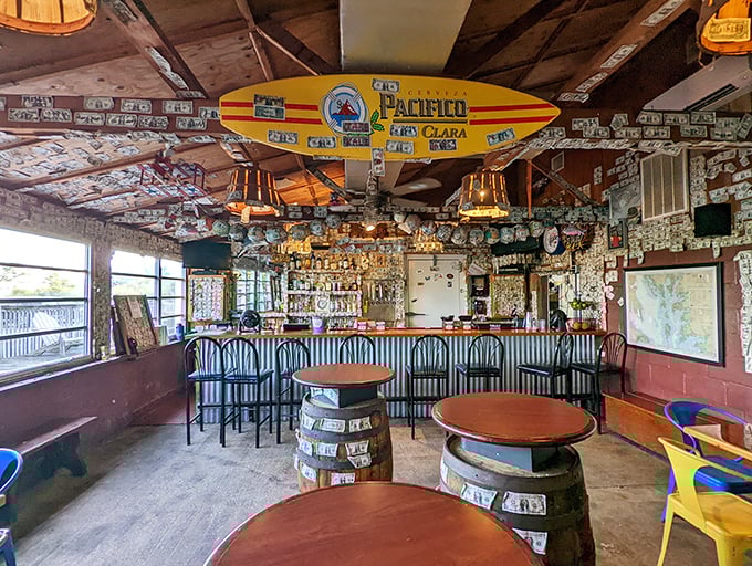 The bar area, where dollar bills cling to walls like memories and every surfboard tells a story of good times and great drinks.