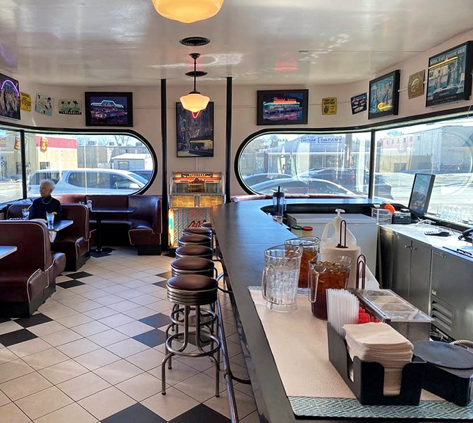 The curved counter with its row of stools – where solo diners find community and regulars have worn their favorite spots into the vinyl.
