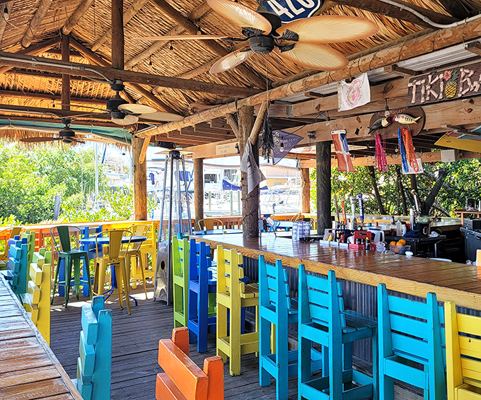 The tiki bar's rainbow of chairs isn't just seating – it's a mood enhancer. Even the barstools are on island time.