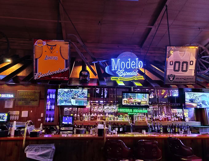The bar at Cattlemens—where sports memorabilia meets neon beer signs in perfect harmony. A watering hole worthy of post-trail cowboys and modern-day carnivores alike.