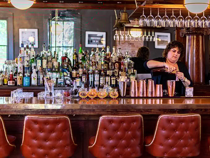 A bar stocked for serious cocktail enthusiasts. Those red leather chairs have probably heard some good stories over the years.