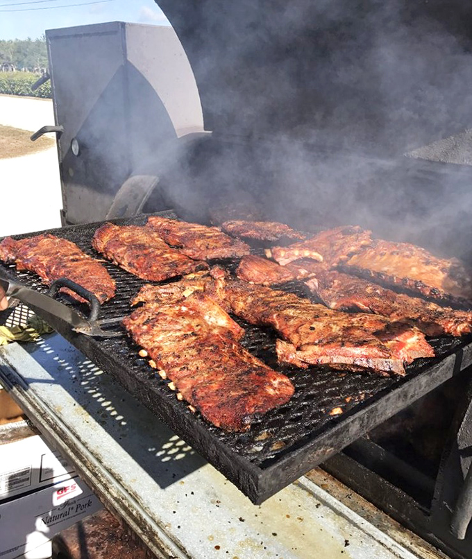 Where the magic happens – racks of ribs transforming from mere meat to transcendent barbecue in clouds of fragrant smoke.
