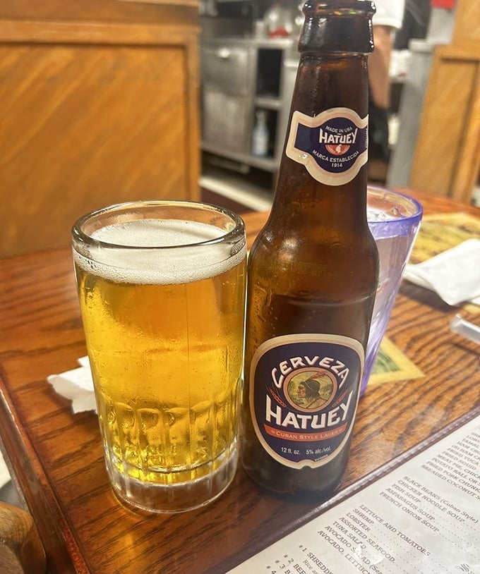 A cold Hatuey beer, the perfect companion for any Cuban feast—like finding an old friend at the table.