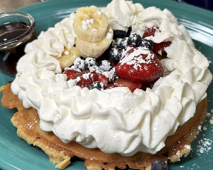 This isn't just a waffle—it's a platform for berry brilliance and whipped cream architecture that would make Frank Lloyd Wright jealous.