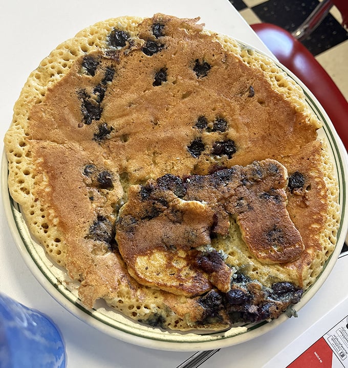 This blueberry pancake isn't just big—it's the size of a frisbee with enough berries to qualify as a fruit serving. Almost.